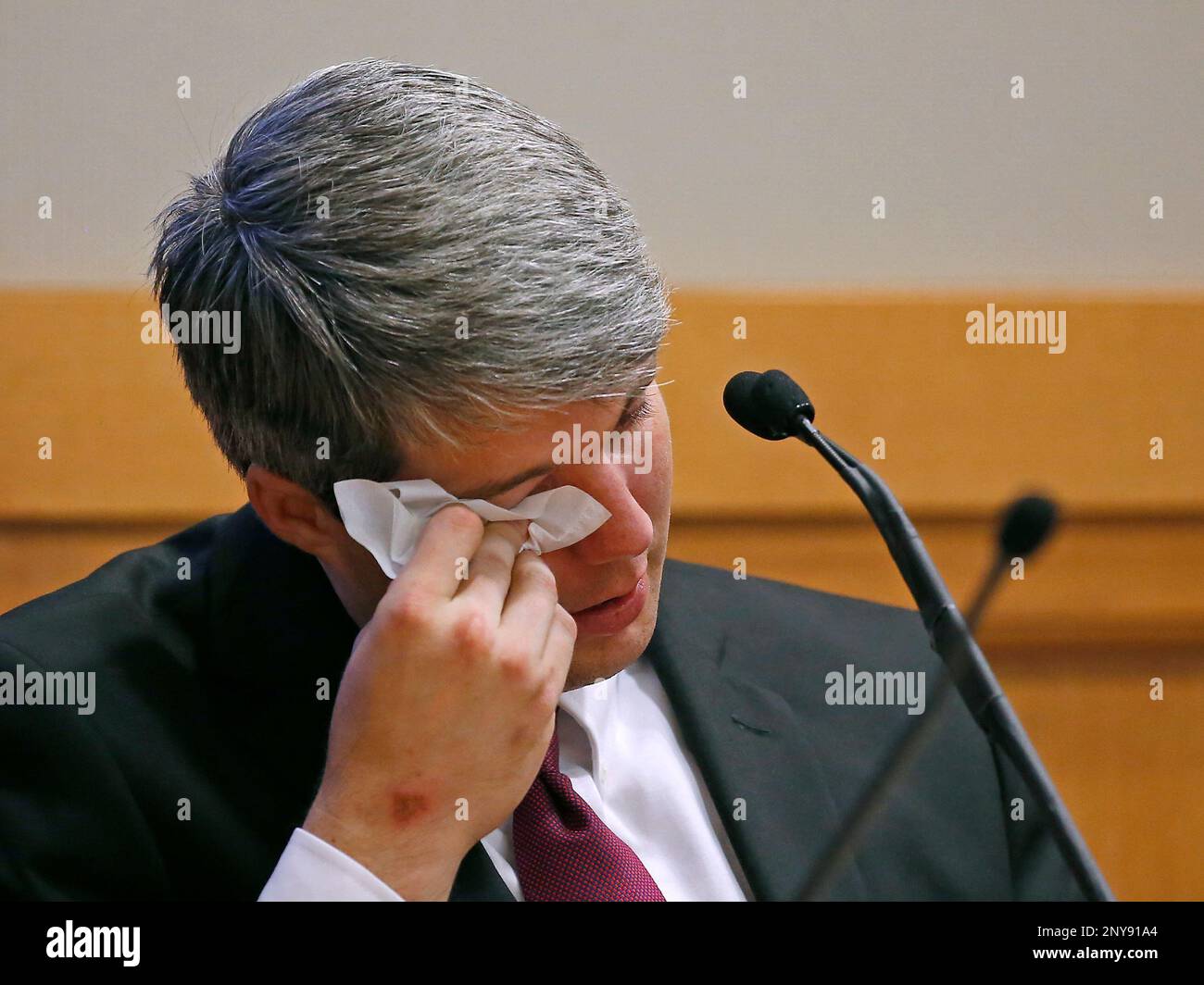 Defendant Jason Lowe wipes tears away while he testifies during his ...