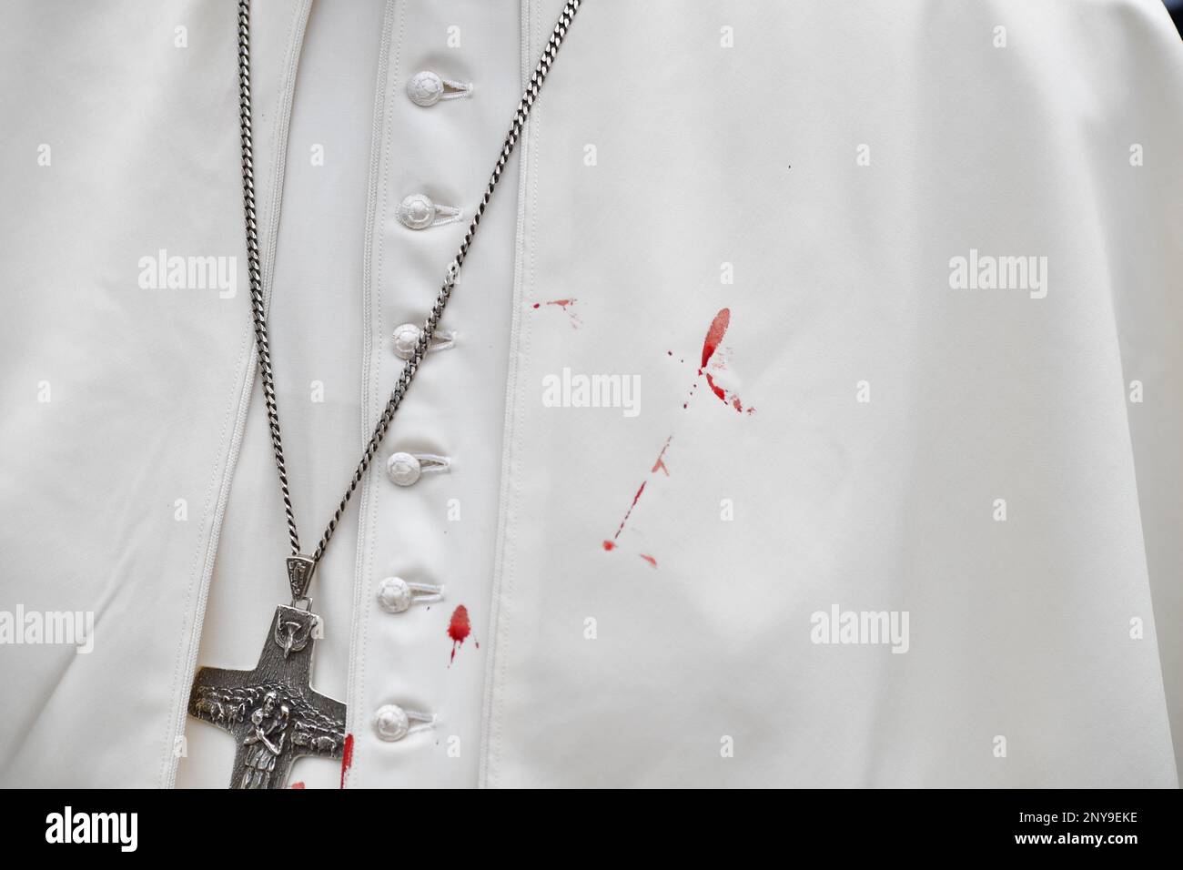 A drops of blood stain Pope Francis' white cassock after he knocked his ...