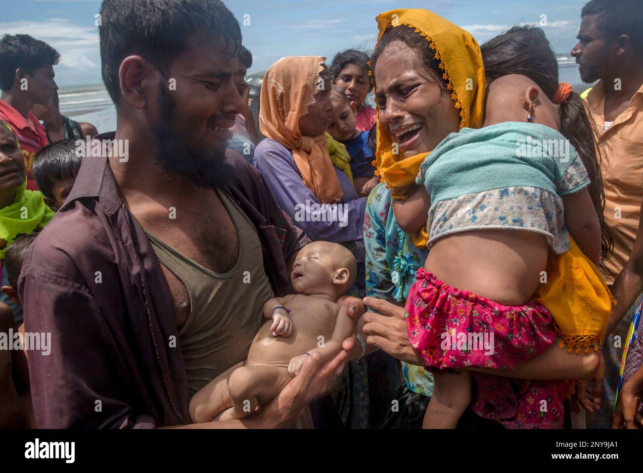 A Rohingya Muslim man Naseer Ud Din holds his infant son Abdul Masood ...