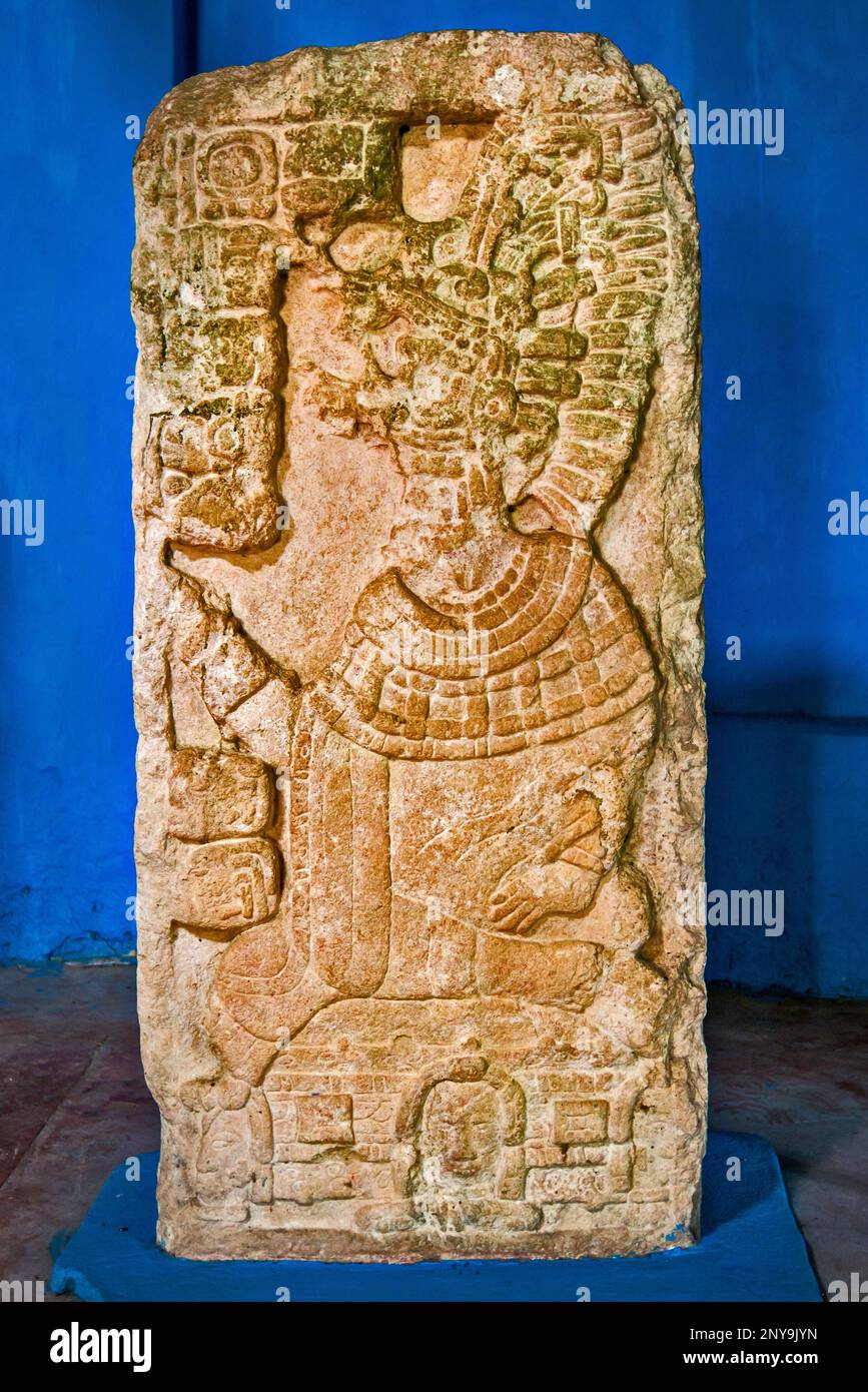 Stone stela displayed under a palapa at Edzna archaeological site ...