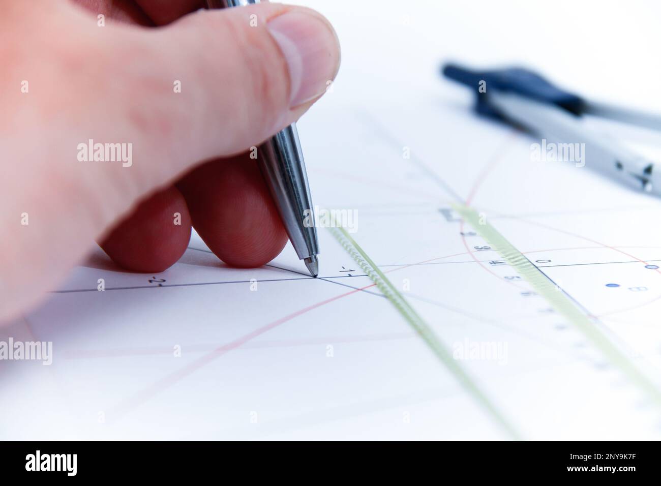 Professional architect working at his desk, measuring and estimating ...