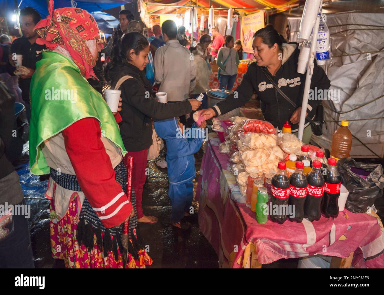 Costumed procession participant at market stall, Plaza Municipal ...