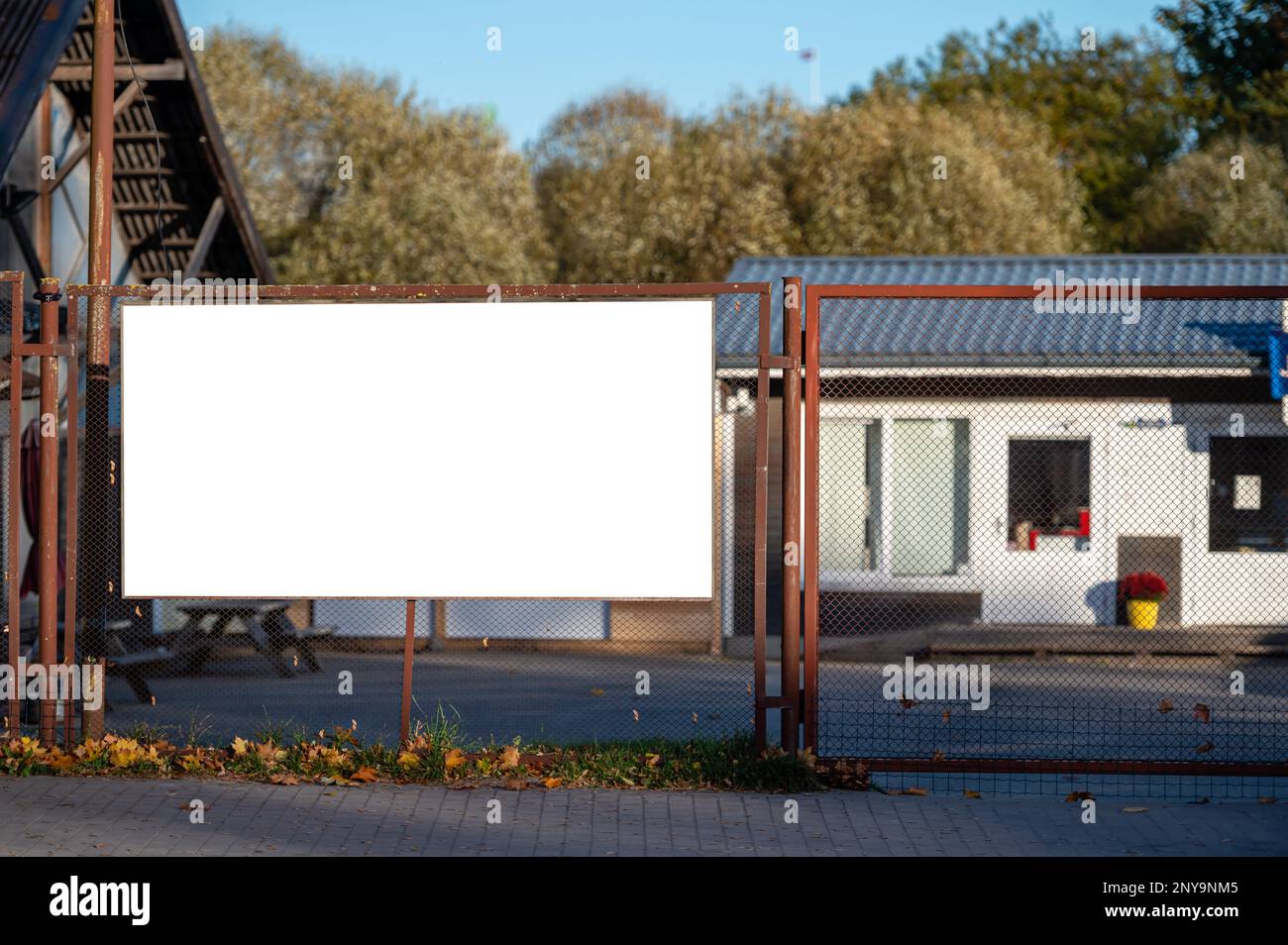 Blank white advert banner with mockup space on metal fence Stock Photo ...