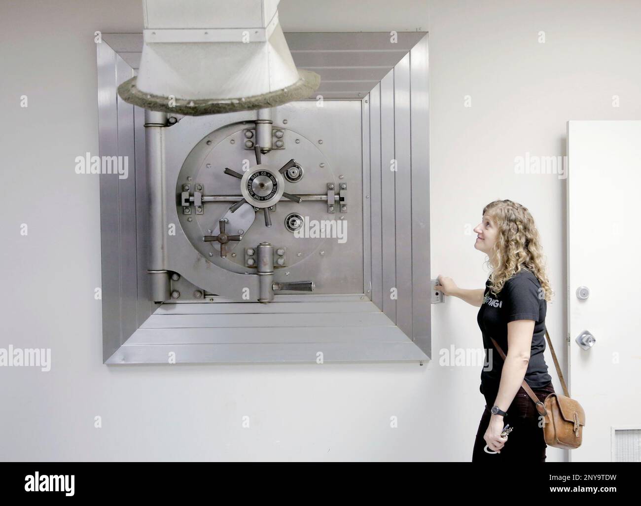 Libby Billings raises an air-conditioning vent used to cool the Vault ...