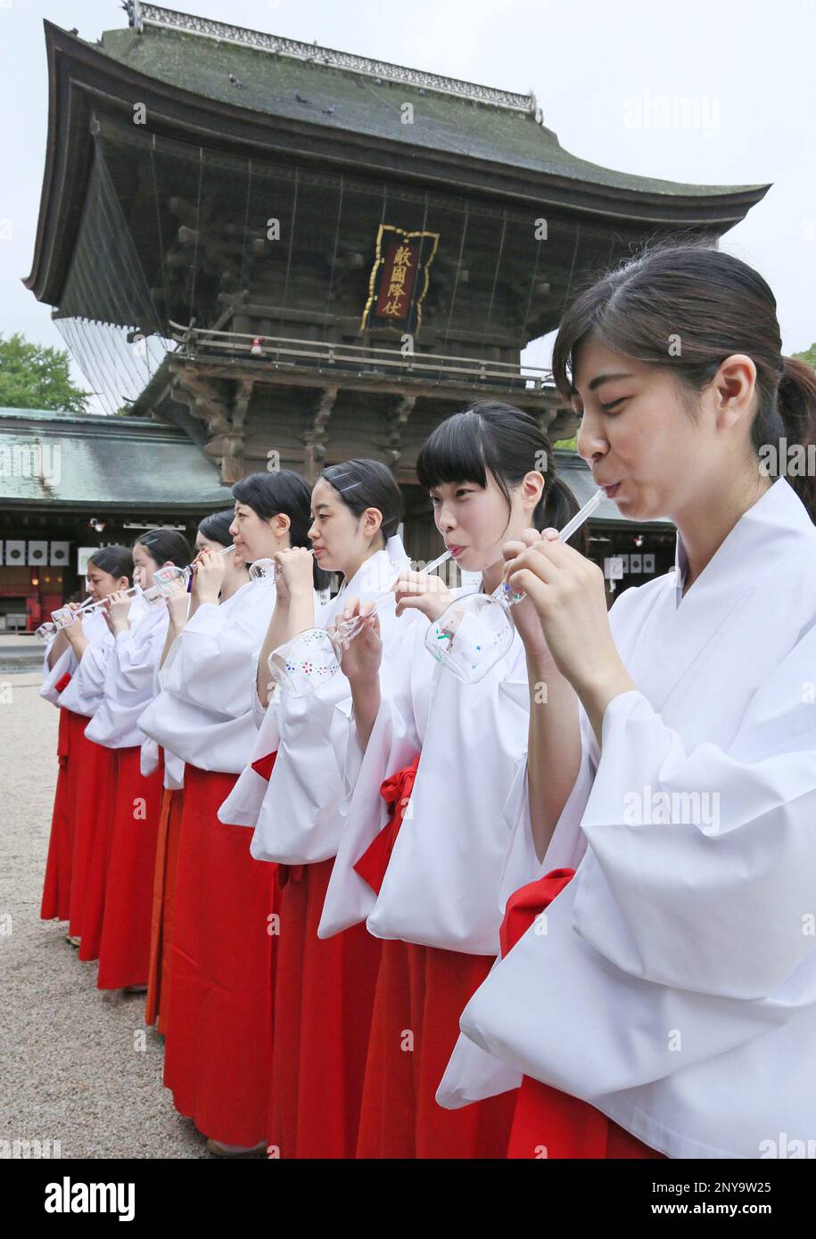 Miko, Japanese Shinto female attendants play the lucky charm glasswork ...