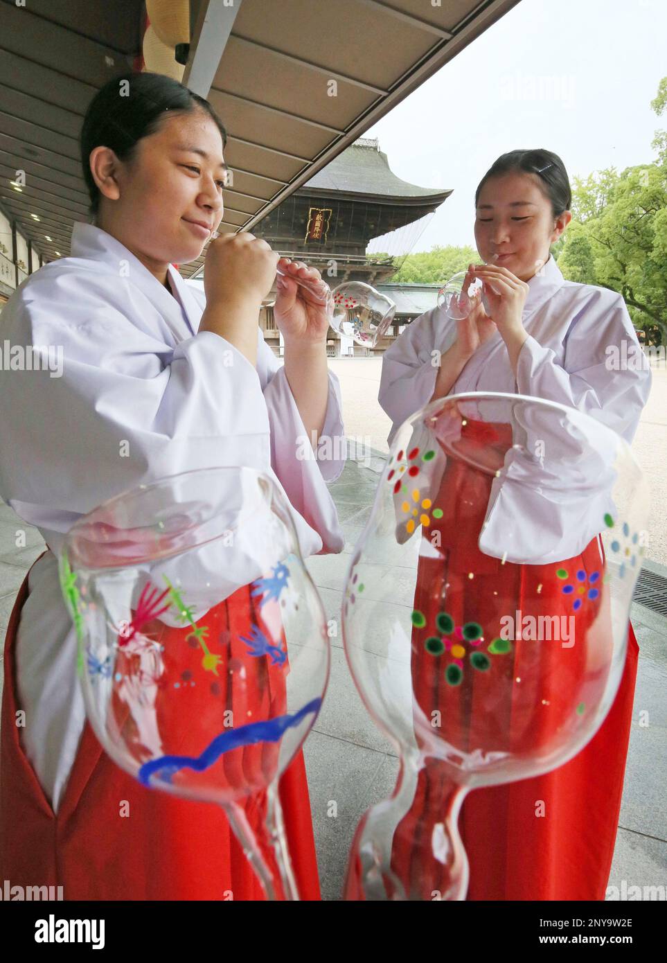 Miko, Japanese Shinto female attendants play the lucky charm glasswork ...