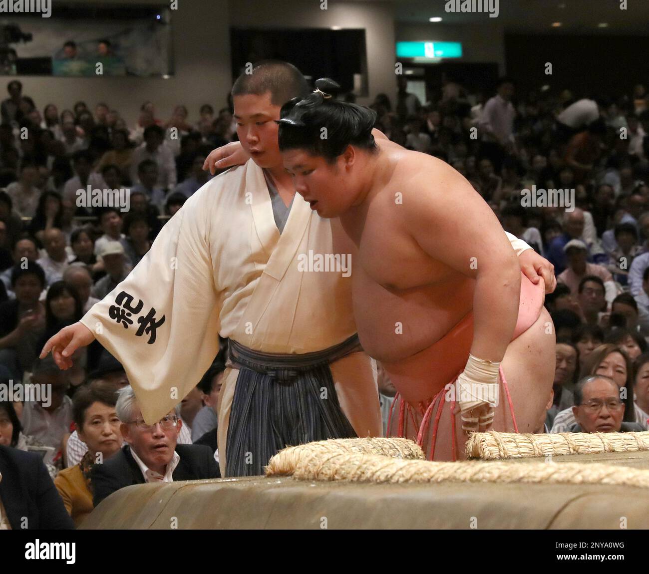 Japanese No.4 maegashira Ura (R) is beaten by Japanese No.5 maegashira ...