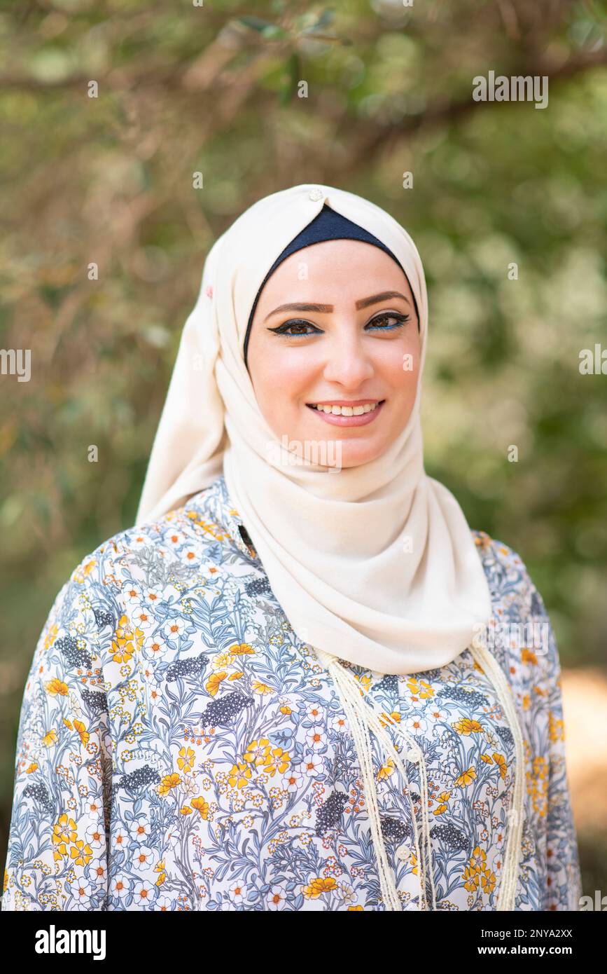 Beautiful Muslim woman looking at camera smiling outdoors Stock Photo ...