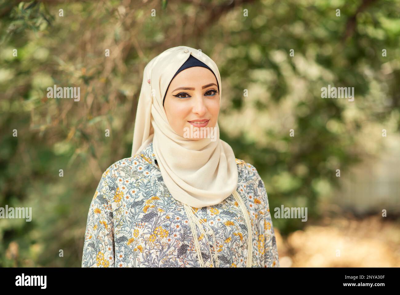 Beautiful Muslim woman looking at camera smiling outdoors Stock Photo ...