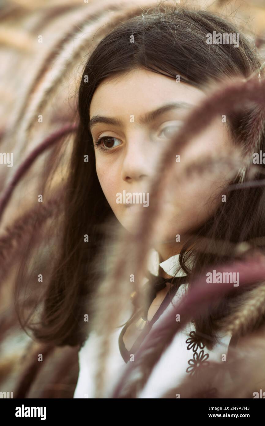 Scared little girl looking away outdoors Stock Photo - Alamy