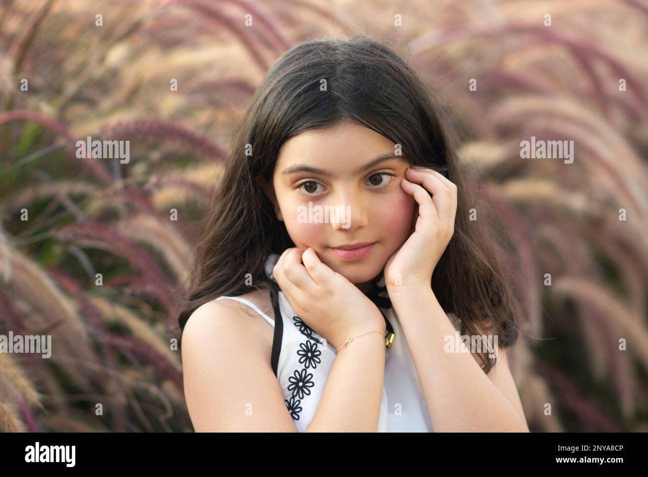 Beautiful Girl Hands Touching Face Looking At Camera Outdoors Stock