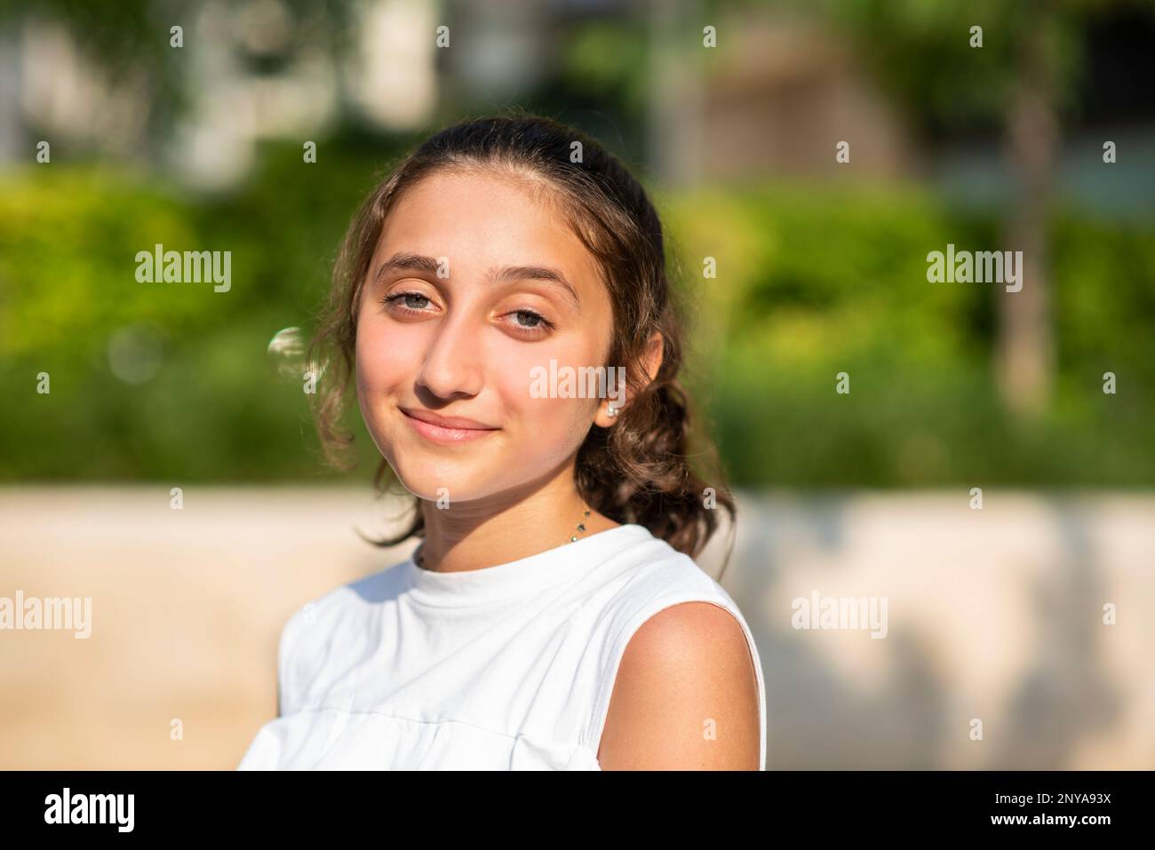 Beautiful teenage girl looking at camera outdoors Stock Photo - Alamy