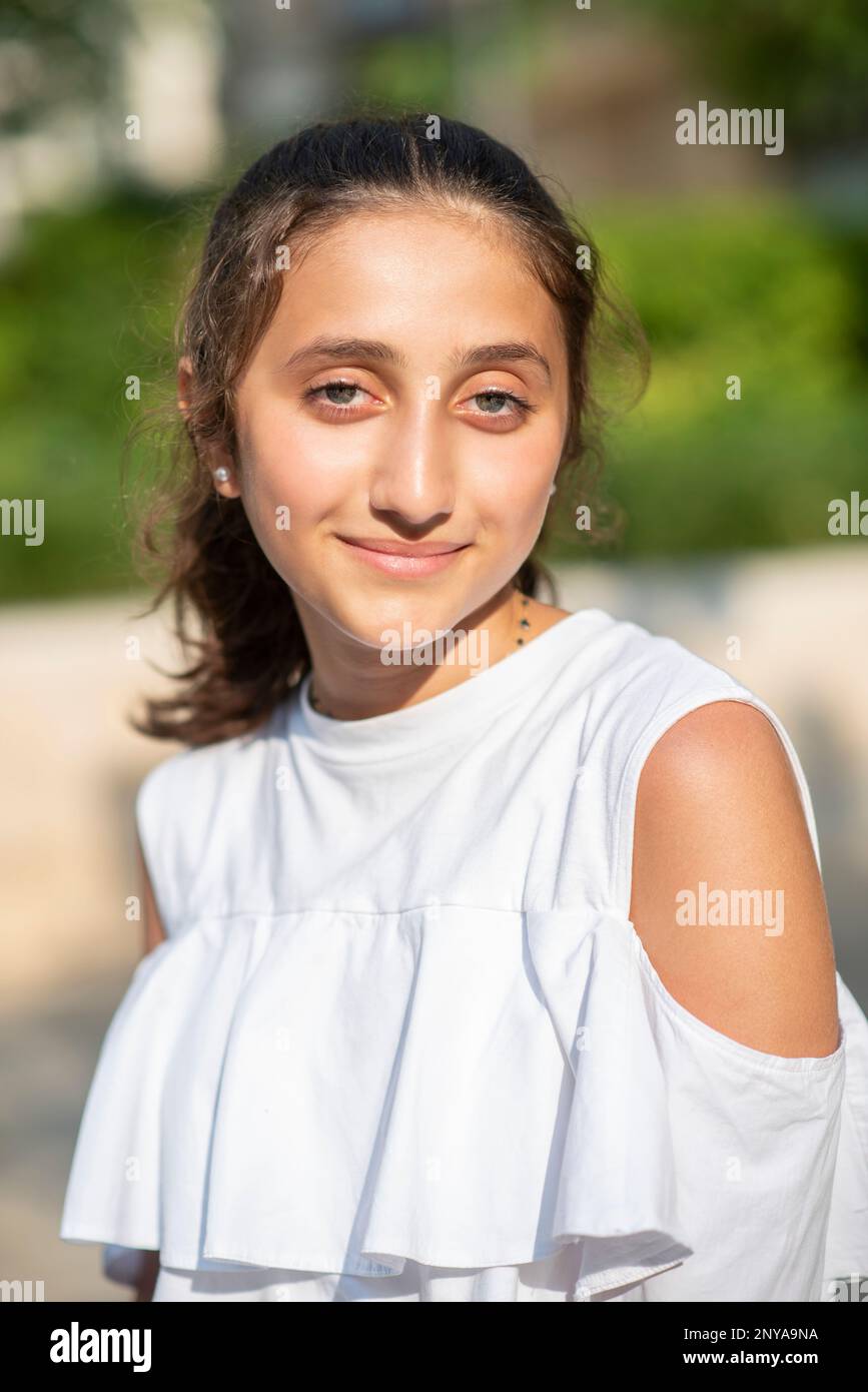 Beautiful teenage girl looking at camera outdoors Stock Photo - Alamy