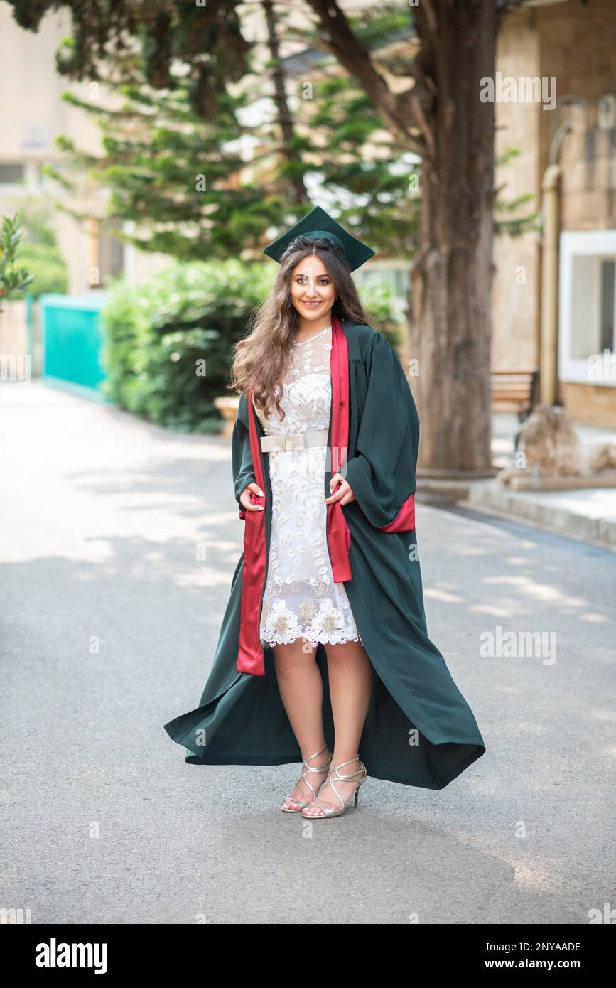 Beautiful female gradute outdoors Stock Photo - Alamy
