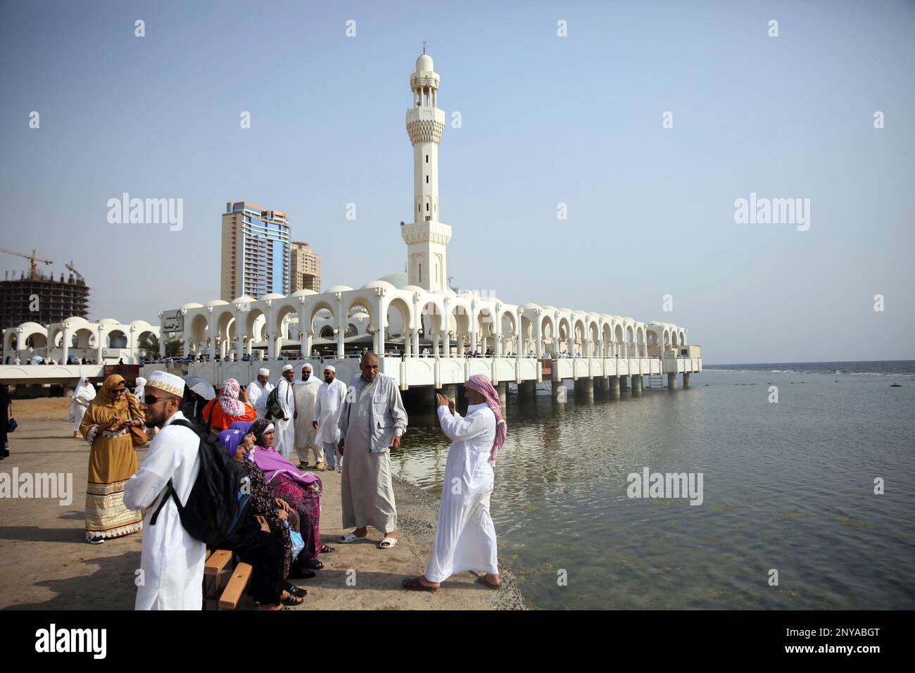 People take pictures at Al-Rahma Mosque, which is also famously known ...