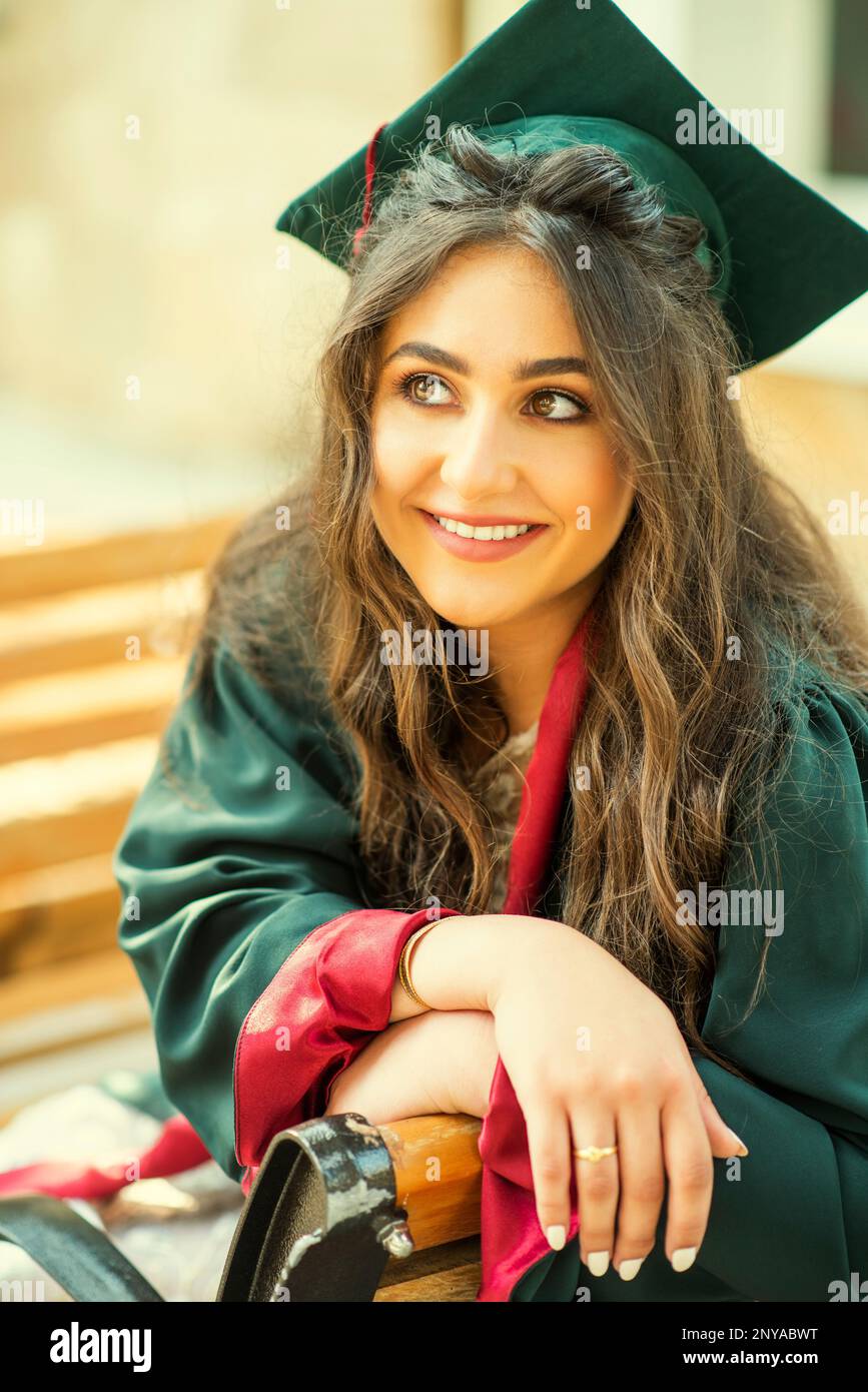 Beautiful female gradute outdoors Stock Photo - Alamy