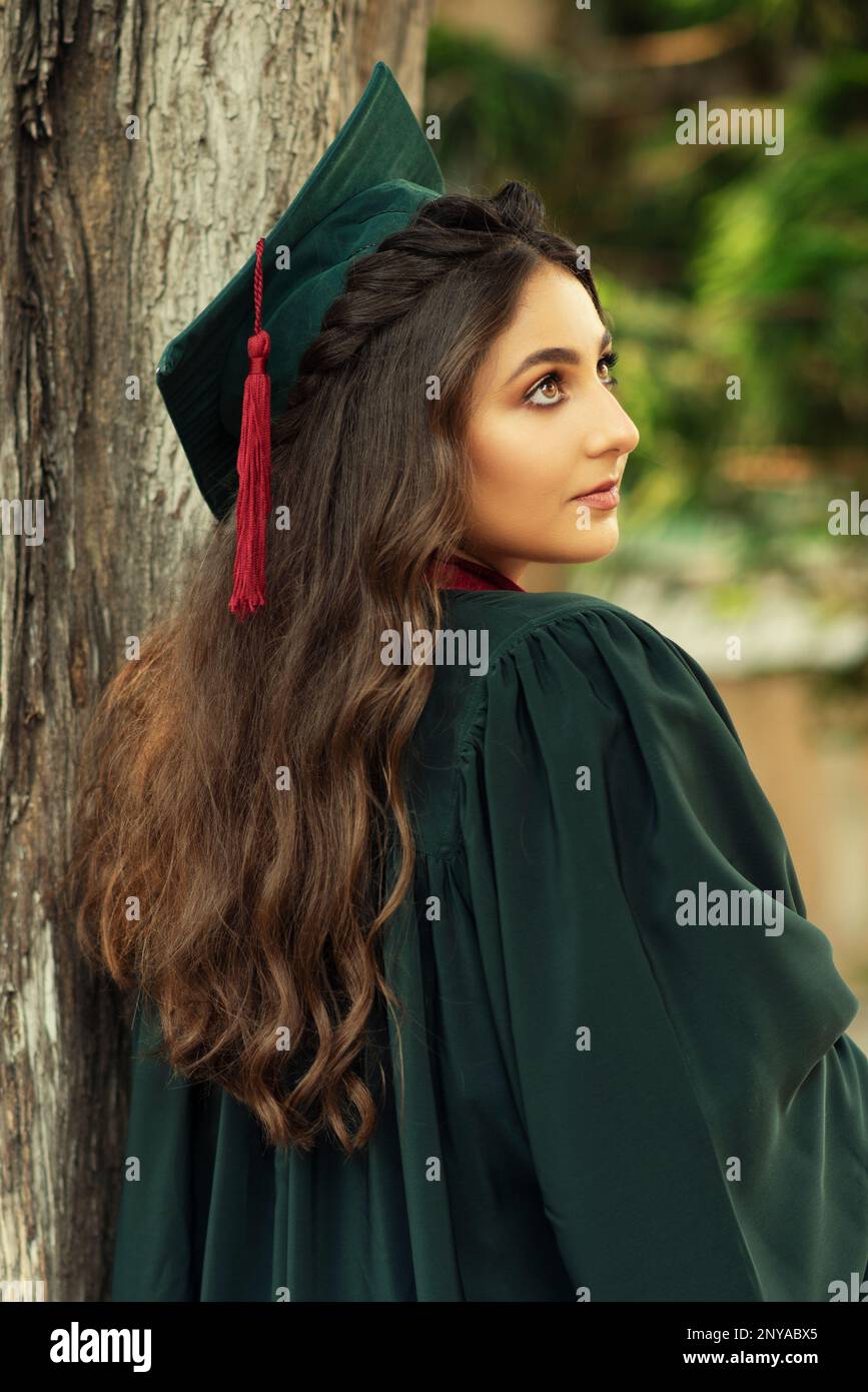 Beautiful female gradute outdoors Stock Photo - Alamy
