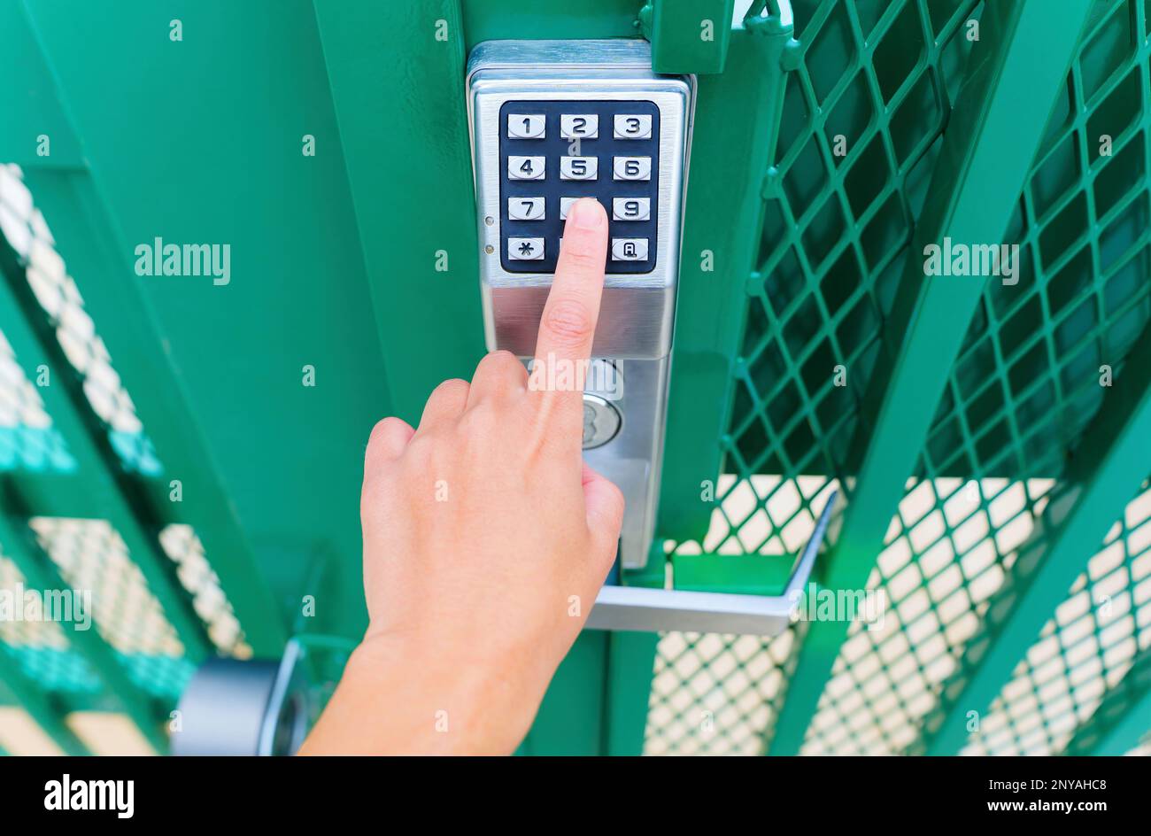 Finger presses a digit on a keypad to open the mechanical code lock ...