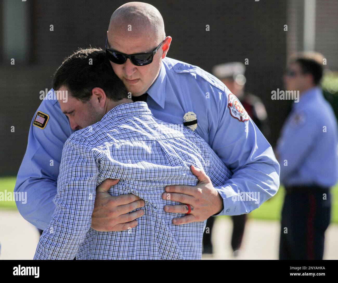 Meridian Firefighter Capt. Jeff Stuart is hugged by fellow firefighter ...