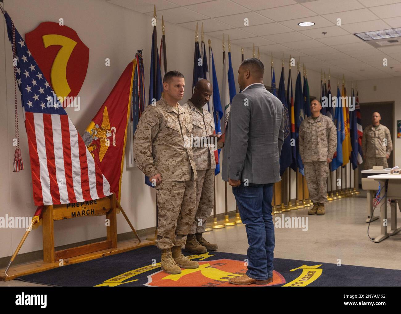 U.S. Marine Corps Col. David J. Hart, (left), accompanied by Sgt. Maj. Idris N. Turay, awards U ...