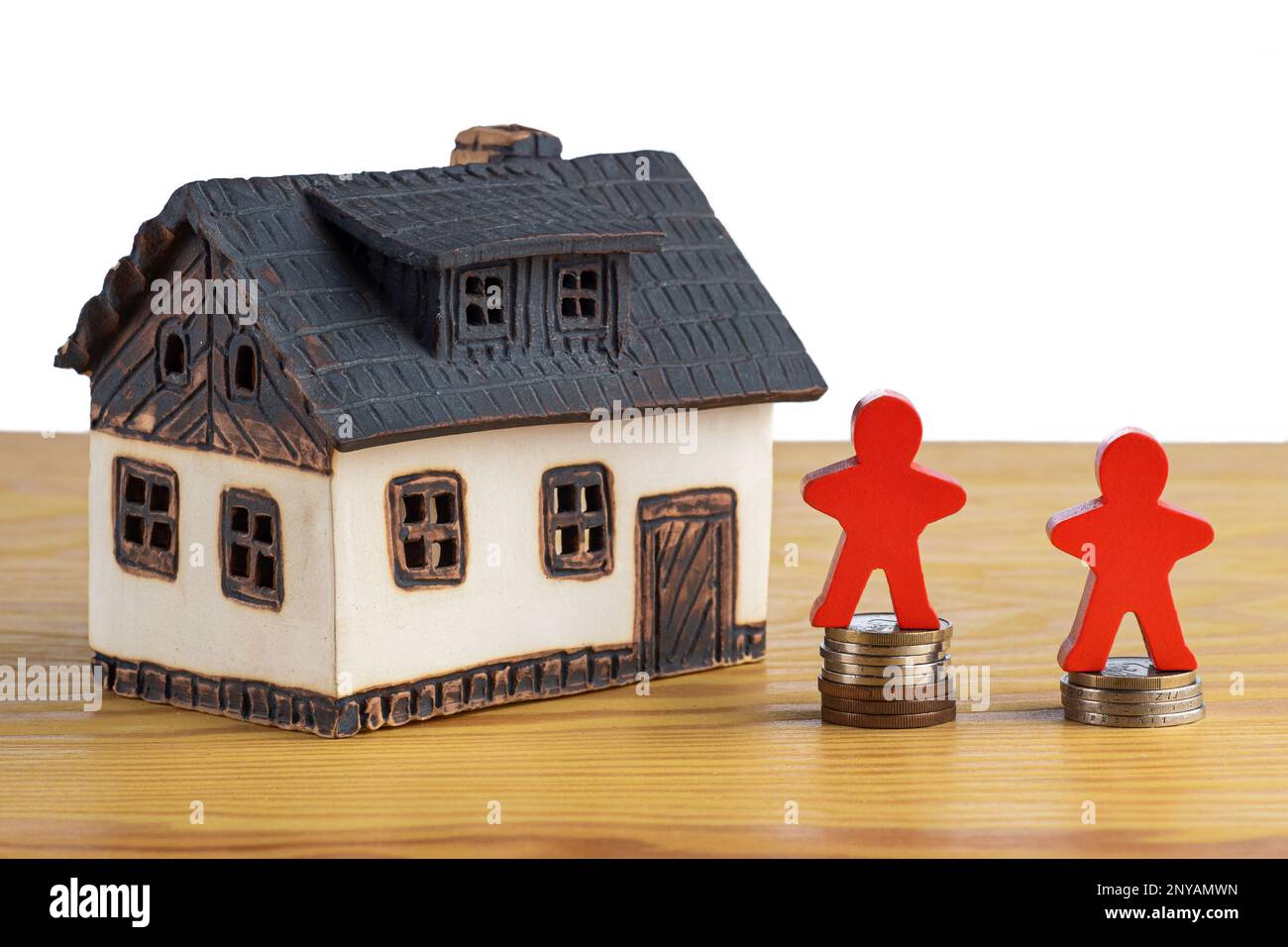 House with stacks of money and a figure model symbolizing rising real ...