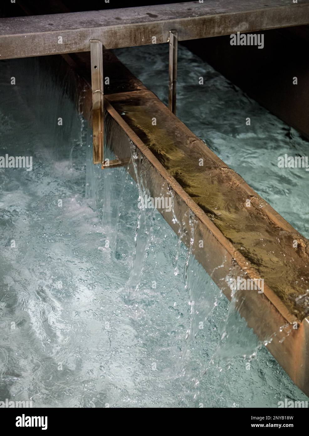 Water fills up a container in the water treatment facility prior to ...