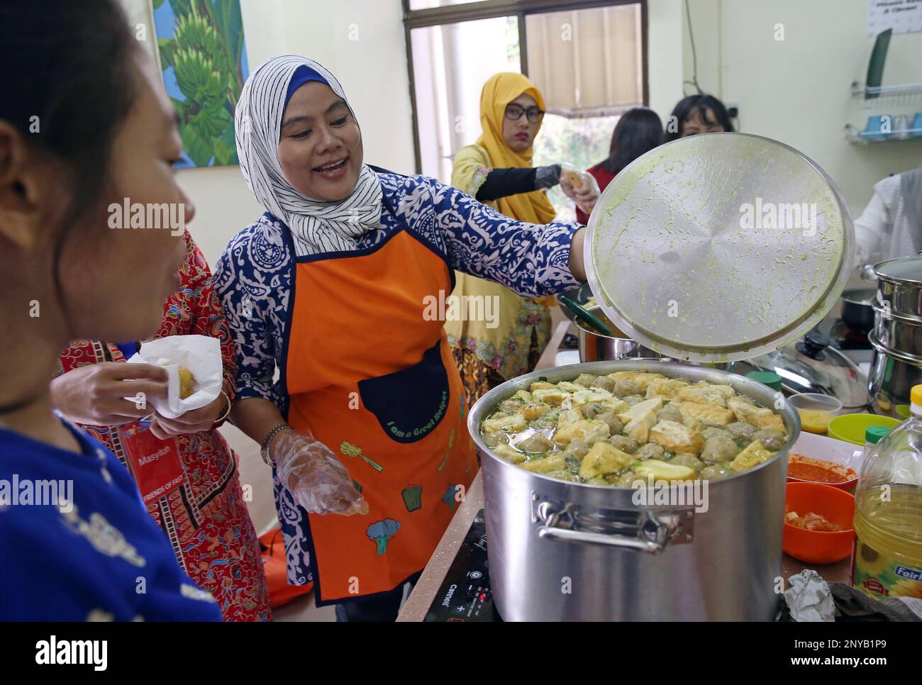 Atik Setyamurti, 42, prepares to taste a pot of 'bakso' which she and ...