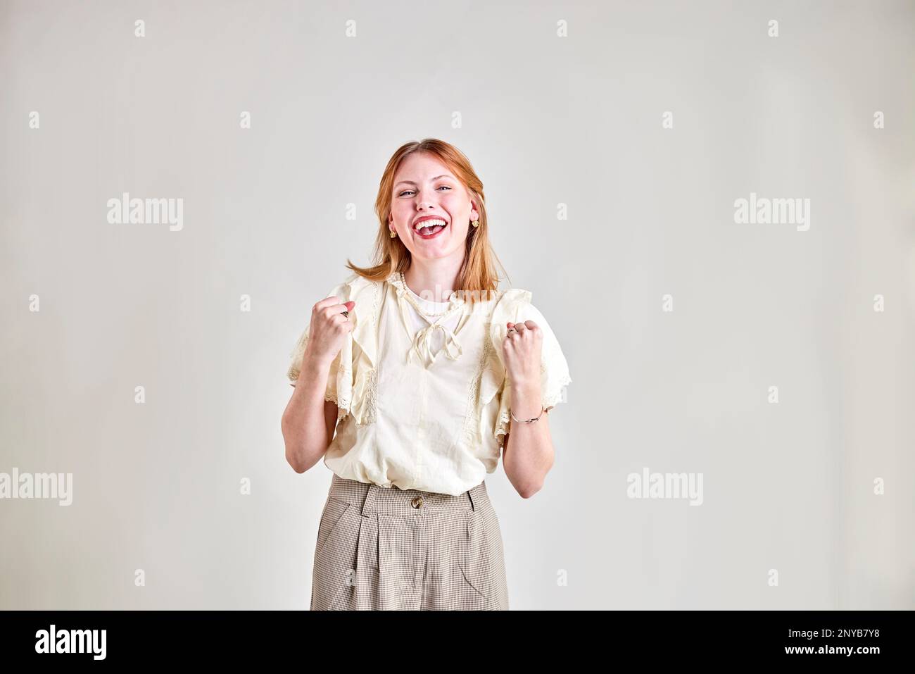 Young woman with red hair very happy and smiling Stock Photo - Alamy