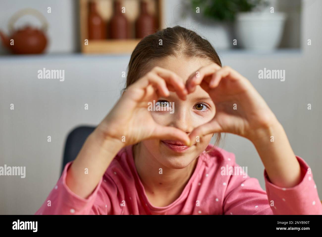 Girl making heart sign with hands hi-res stock photography and images ...