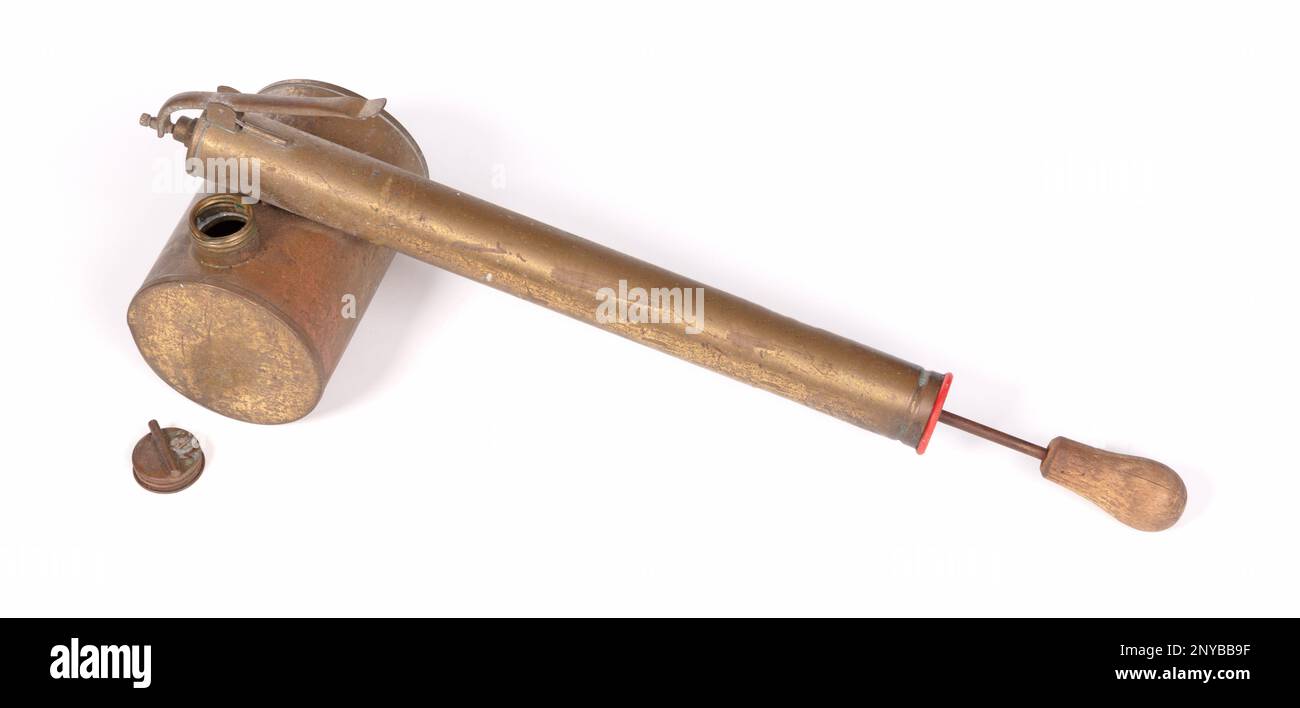 Old brass insecticide spray on a white background Stock Photo - Alamy
