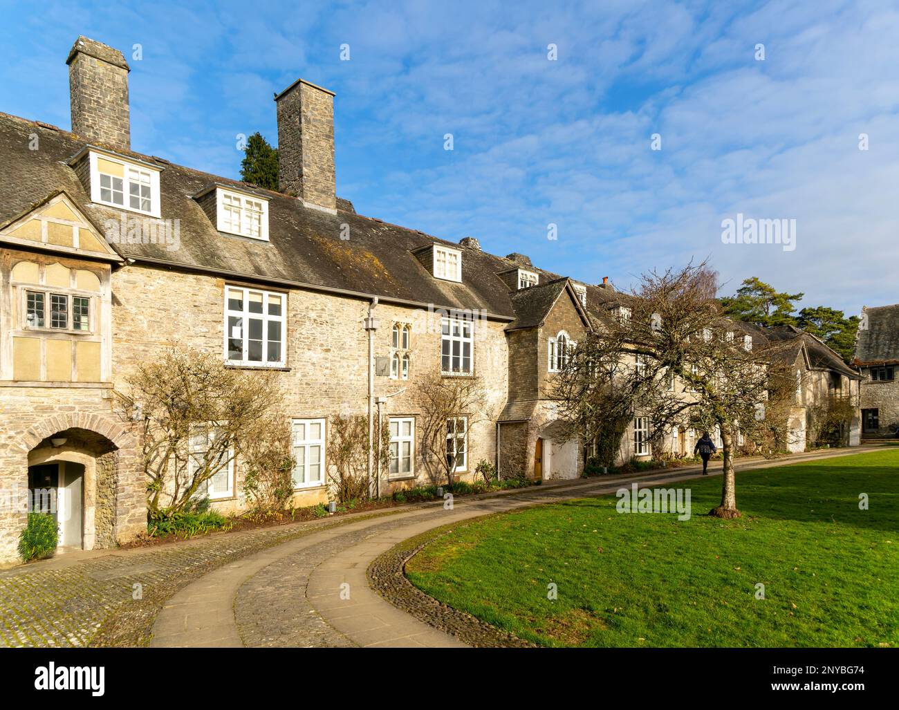 Historic medieval buildings in courtyard of Great Hall, Dartington Hall ...