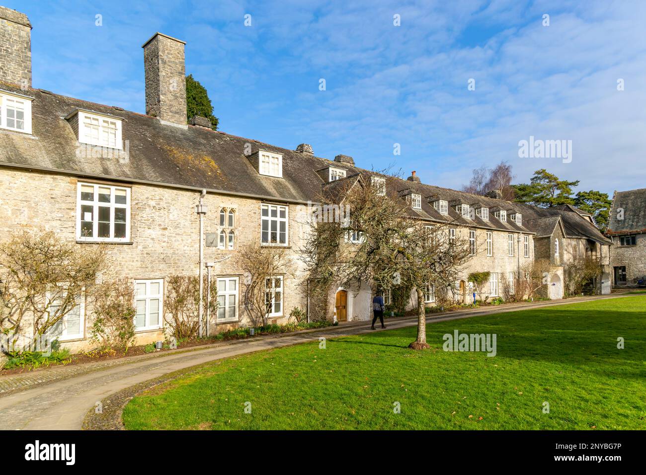 Historic medieval buildings in courtyard of Great Hall, Dartington Hall ...
