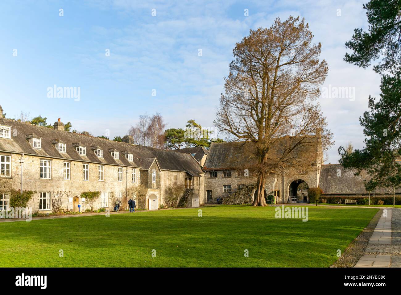 Historic medieval buildings in courtyard of Great Hall, Dartington Hall ...