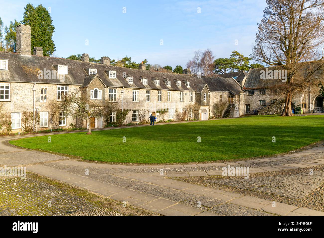 Historic medieval buildings in courtyard of Great Hall, Dartington Hall ...