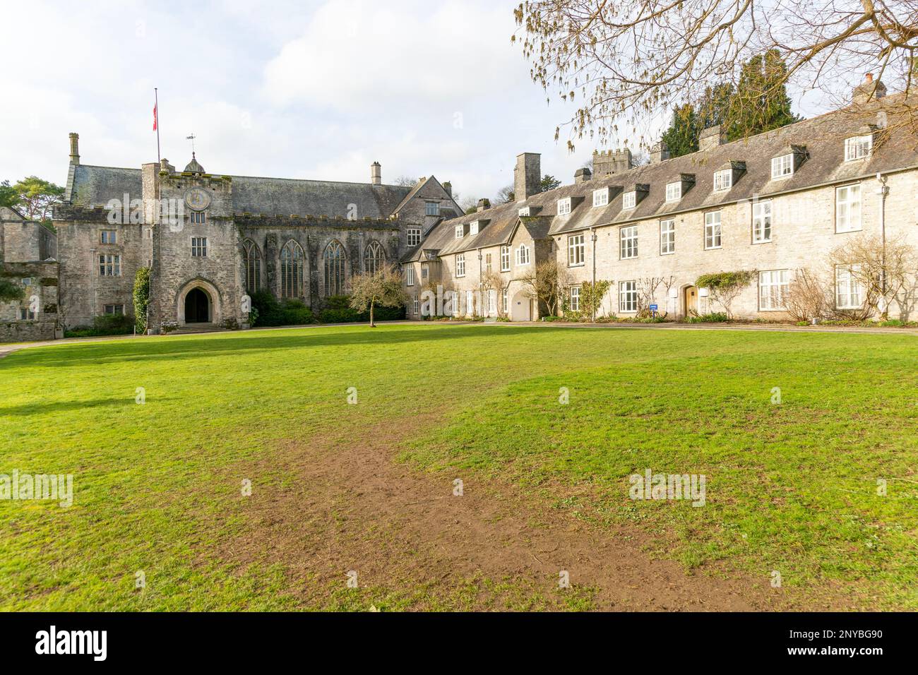 Historic medieval buildings in courtyard of Great Hall, Dartington Hall ...
