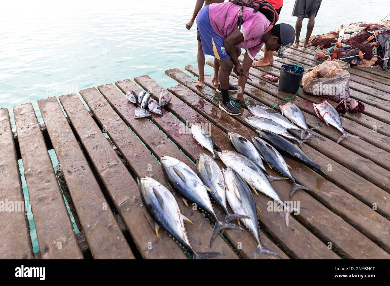Famous wooden pier in Santa Maria town on Sal island, full of fishermen ...