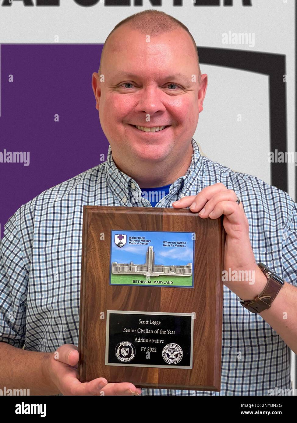 Scott Legge shows the plaque he received for earning Walter Reed ...
