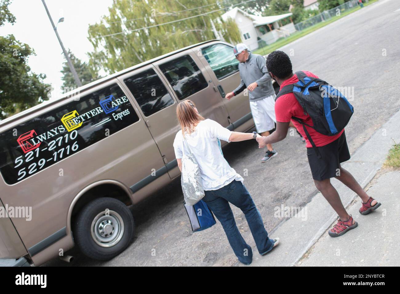 Breann Betzer holds her brother Dakota Betzer as they head to Journeys ...