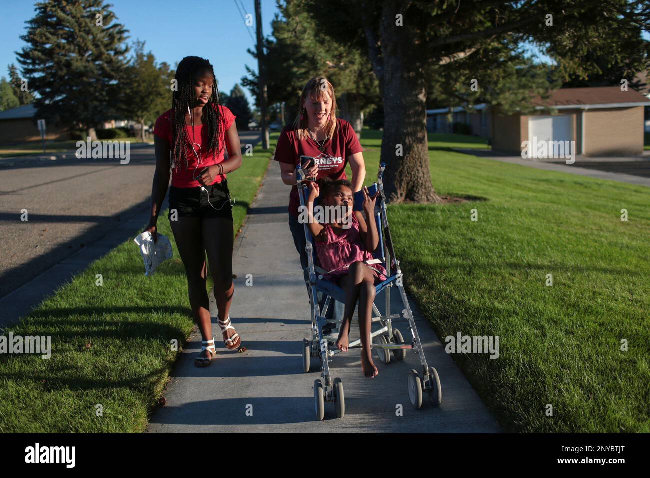 Hannah Betzer walks with Breann Betzer as she pushes her sister Sophie ...
