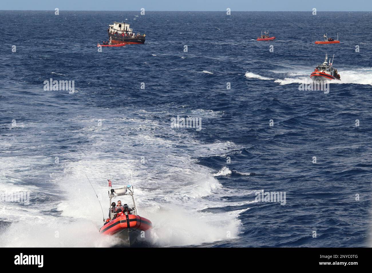 Multiple Coast Guard small boat units converge on the position of an ...