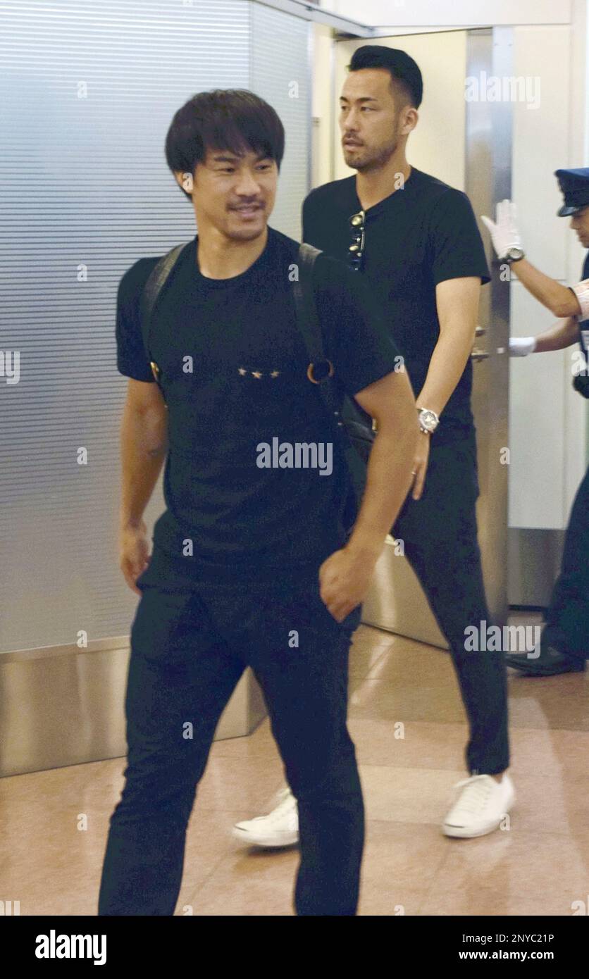 Japanese soccer player Shinji Okazaki (L) arrives at Narita airport on ...