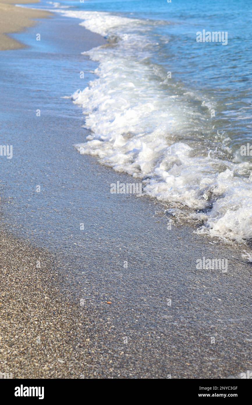 Small Waves Hitting the Sandy Beach Stock Photo - Alamy