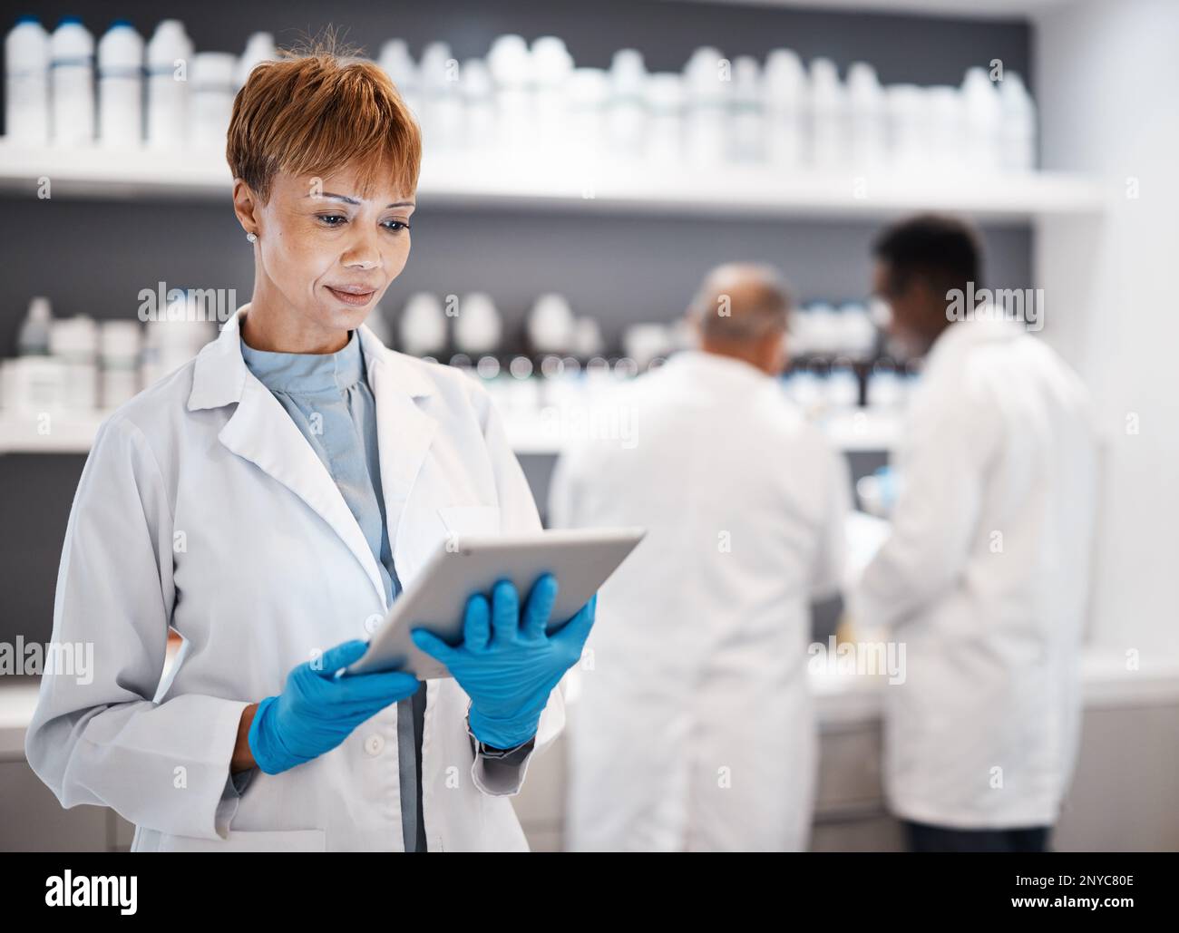 Medical science, tablet and doctor woman in laboratory for research ...