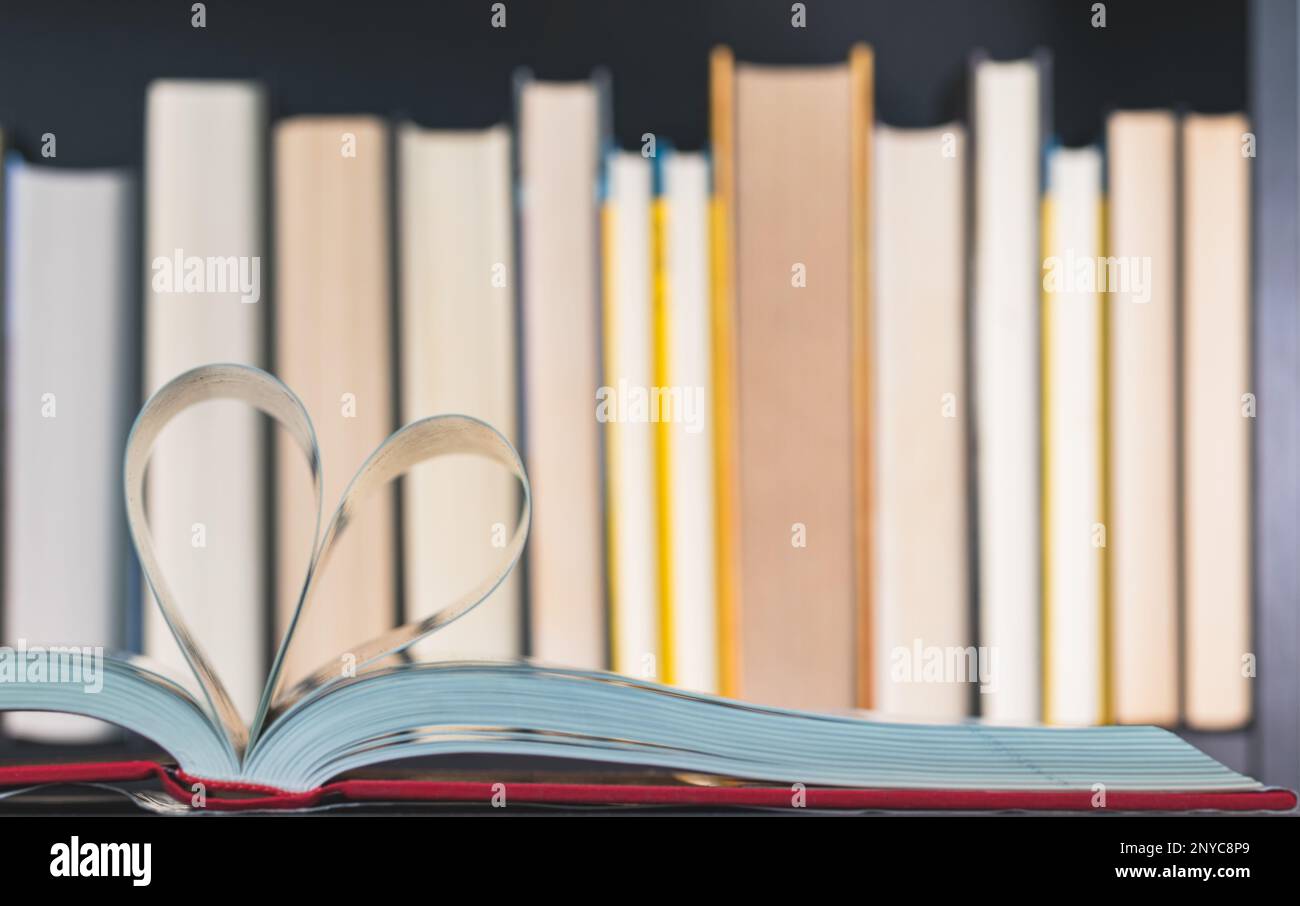 open book with heart-shaped pages with library in the background Stock ...