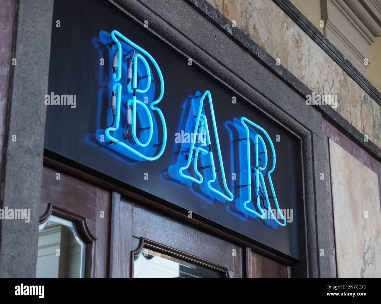 blue neon light bar sign over black Stock Photo - Alamy