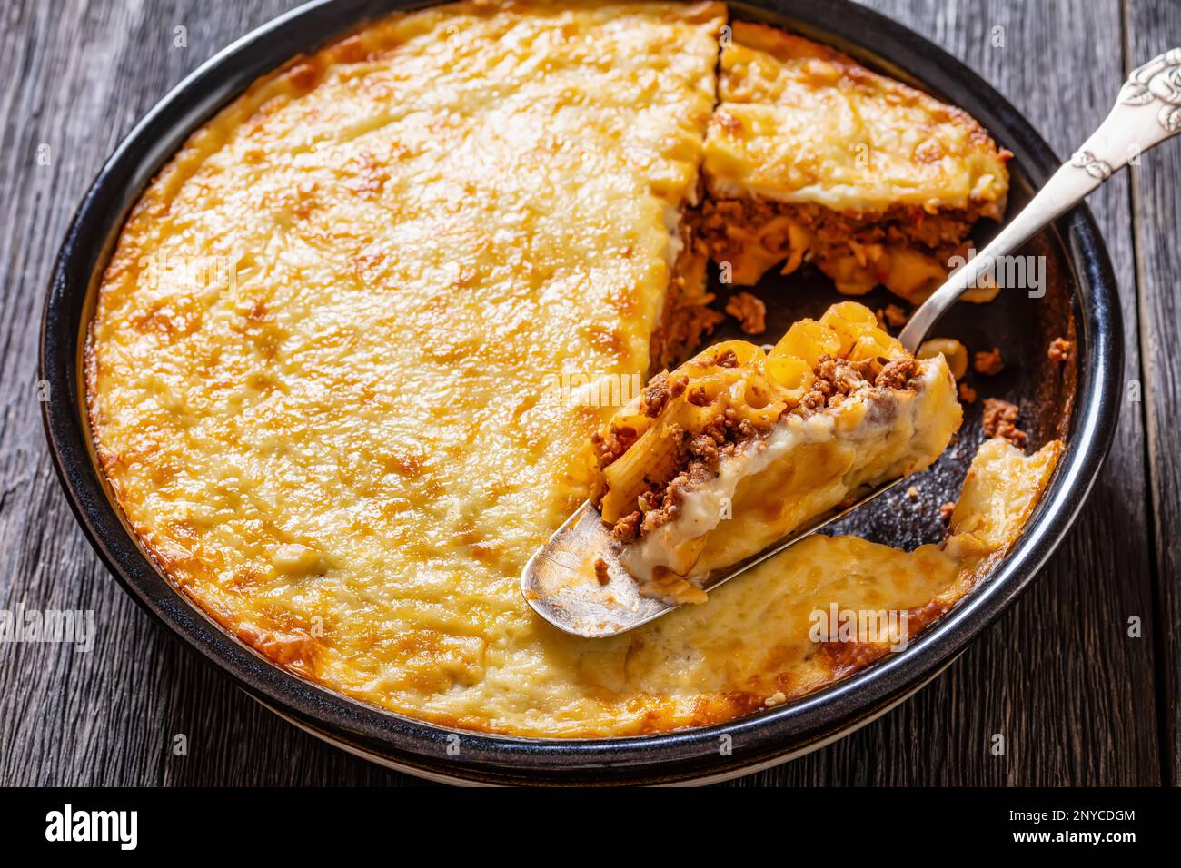 Greek Pastitsio of penne, ground lamb, grated cheese, and tomatoes ...