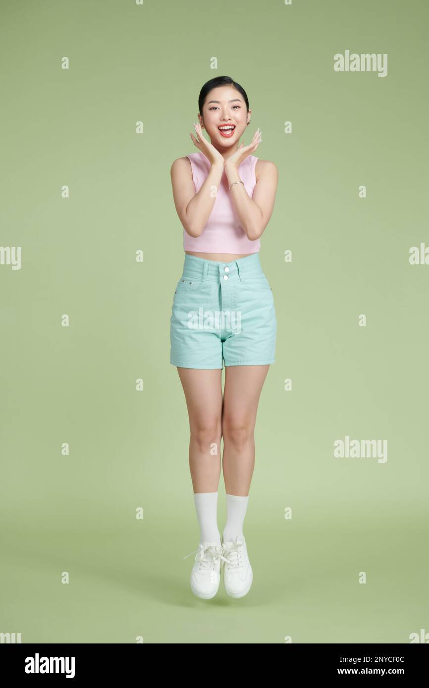 Full size photo of pretty nice cute woman jump up air smile hold hands ...