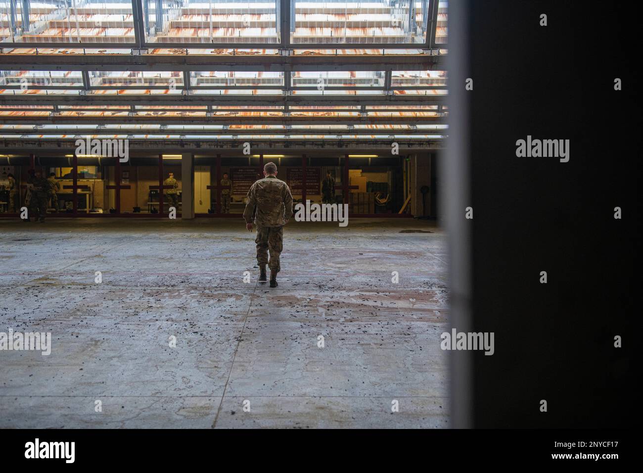 An Airman walks back to the firing line after setting up his target at ...