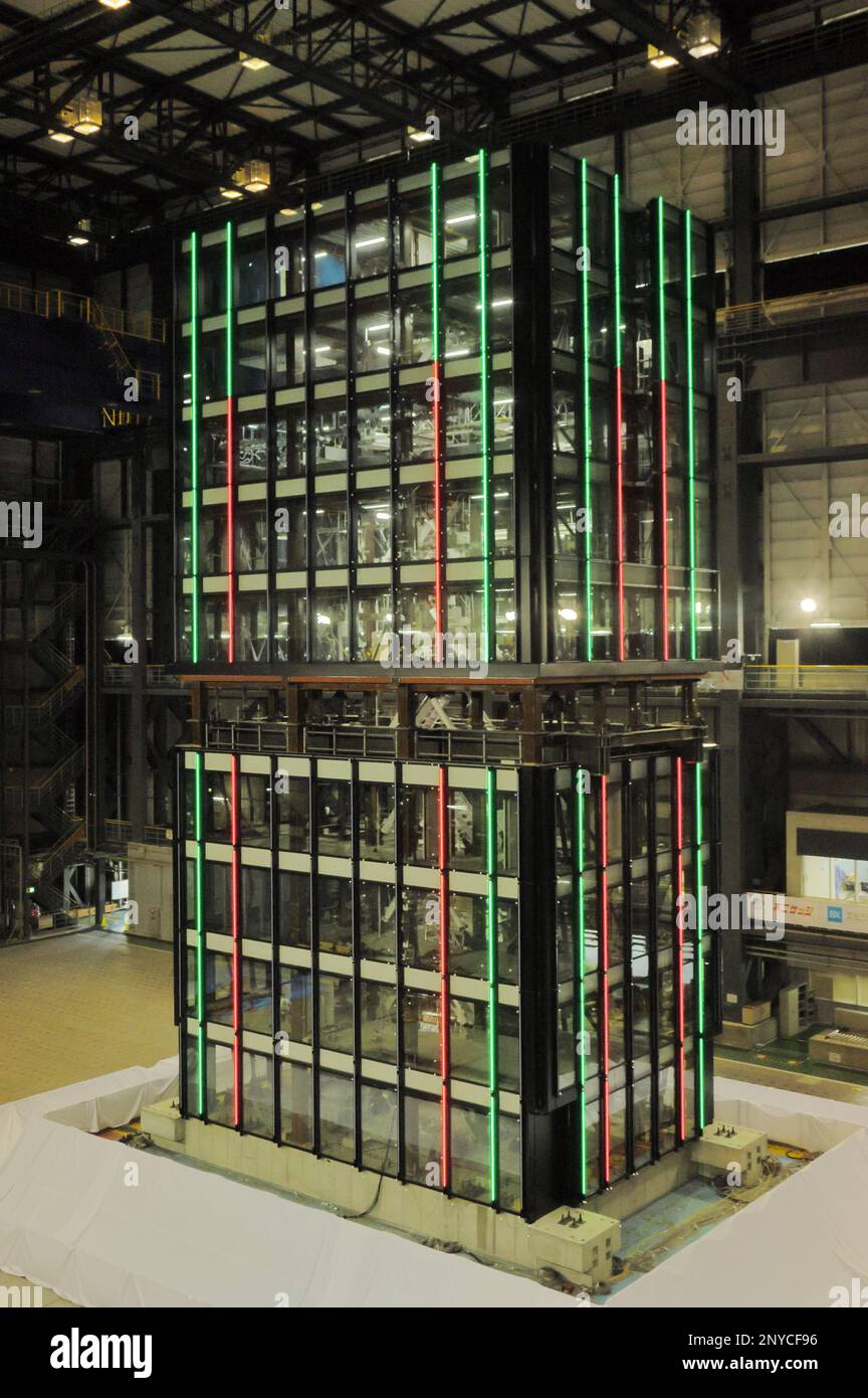 Redand green lights are lit on about 27-meter-high model of a building ...