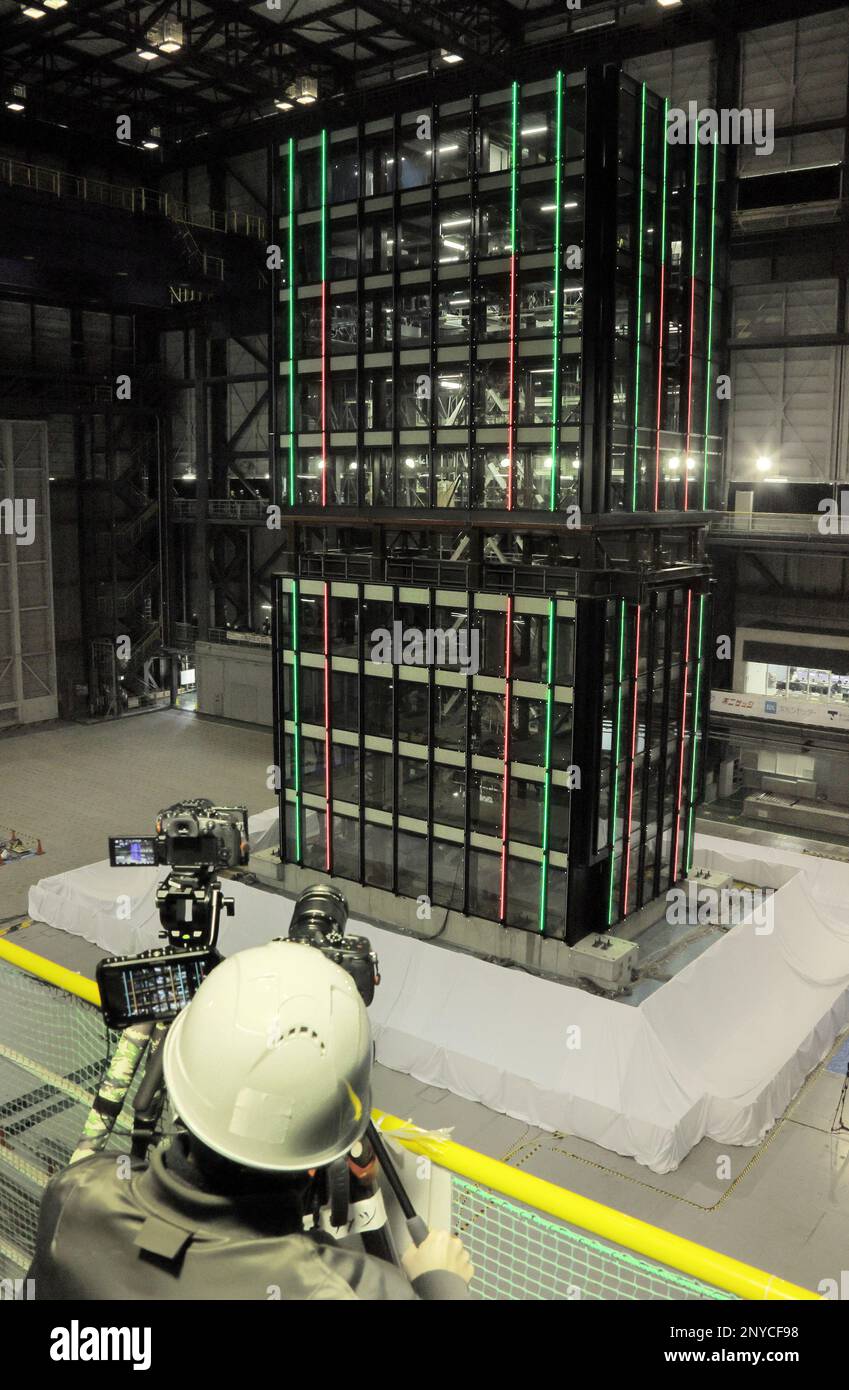 Redand green lights are lit on about 27-meter-high model of a building ...